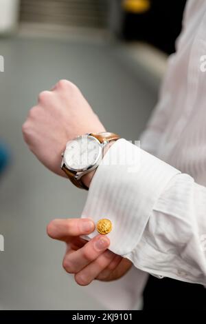 Man buttons cuff-link on French cuffs sleeves Stock Photo - Alamy