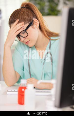 Tired medical assistant in her office Stock Photo - Alamy
