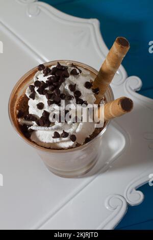 A closeup of Frappe de chocolate Blanco ice cream on a white tray on ...