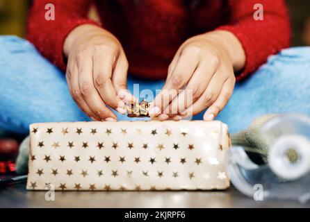 Woman putting a gift box with ribbon in a shopping bag, copy space ...