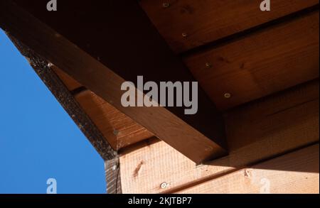 Abstract wooden architecture details, inner roof surface under blue sky ...