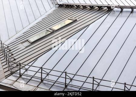 Shiny metal roof with railings and attic windows, modern architecture ...