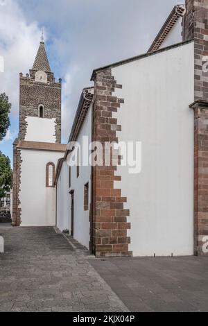 A vertical shot of the Cathedral of Funchal in the background of ...