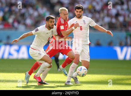 Iran's Morteza Pouraliganji, left, and Wales' Gareth Bale go for a ...