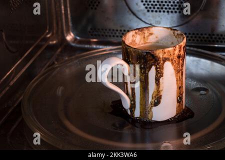 Spilt overflowed coffee drink in microwave causing serious mess to ...