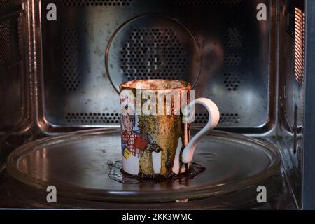 Spilt overflowed coffee drink in microwave causing serious mess to ...