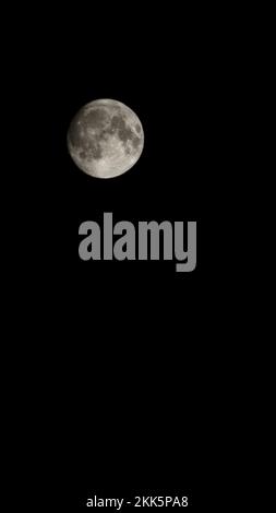 A scenic zoomed-in shot of the moon in the night sky Stock Photo - Alamy