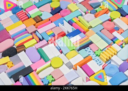 various shapes and colors of erasers arranged isolated on white ...
