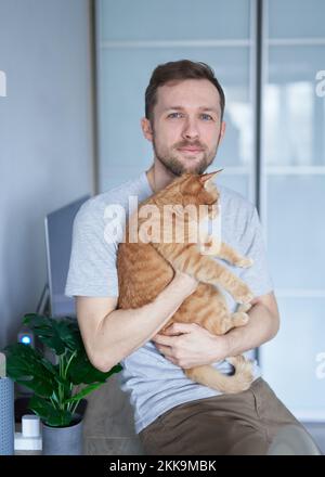 Young confident software developer or IT support manager in grey casual ...