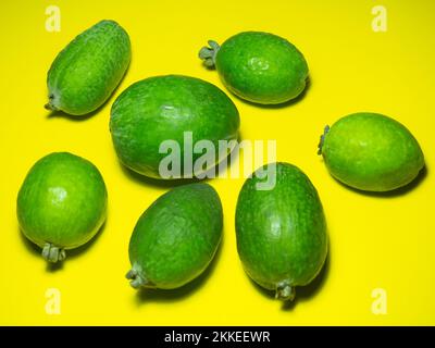 Feijoa on a yellow background. Green fruit on yellow. Feijoa background ...