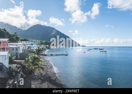 Rocky beach in Dominica, Roseau. Caribbean coastal city with access to ...