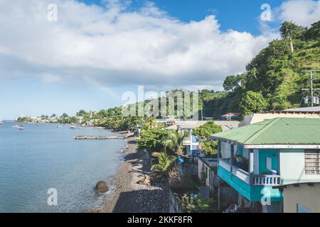 Rocky beach in Dominica, Roseau. Caribbean coastal city with access to ...