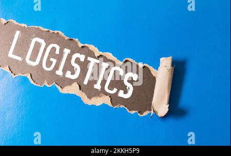 Yellow note paper with word logistics on cork board background with ...