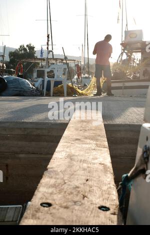 Fisherman, Aegina port, greece Stock Photo - Alamy