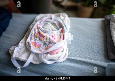 Folding and washing clean baby clothes in a home Stock Photo - Alamy