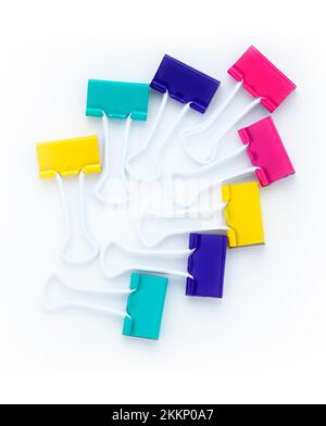 Multicolor binder clips isolated white background. Heap of color ...