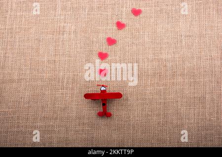 Heart shaped objects before a red airplane Stock Photo - Alamy