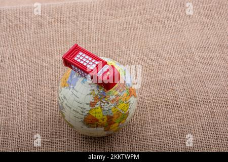 Globe with a telephone booth on canvas background Stock Photo - Alamy