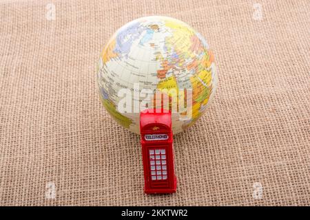 Globe with a telephone booth on canvas background Stock Photo - Alamy