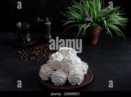 zepfyr on a dark background in a plate in the background - a cup of ...