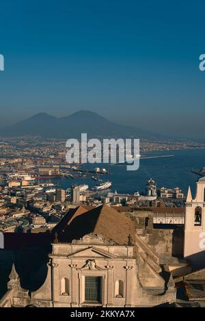 Vertical shot of the Mount Vesuvius surrounded by the sea and buildings ...