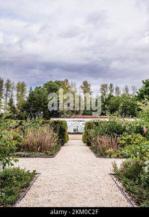 A vertical shot of the elegant Victorian greenhouse at Eythrope Gardens ...
