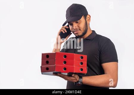 Cheerful pizza delivery person talking on cell phone Stock Photo - Alamy