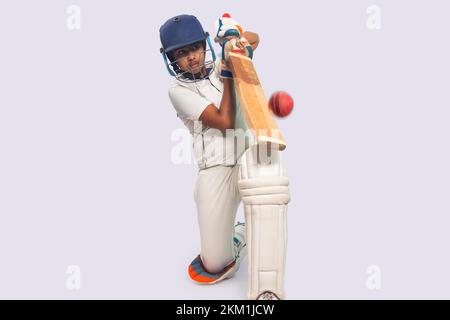 Portrait of boy hitting a shot During a Cricket Game Stock Photo - Alamy