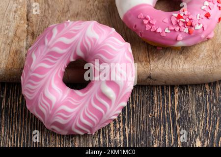 delicious doughnut covered with pink and white chocolate with ...