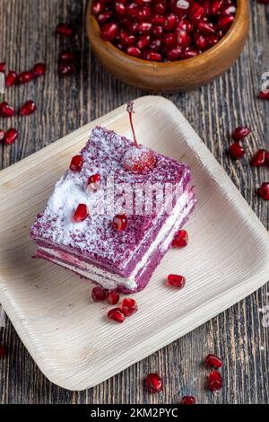 a maroon colored cake with the taste of different berries and a creamy ...