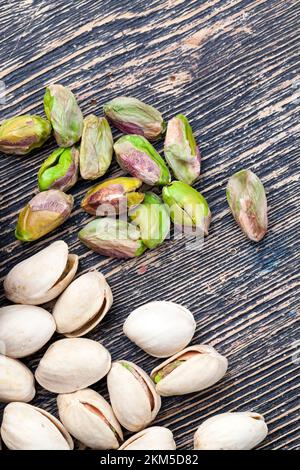 large number of pistachios on a wooden table, fried salted pistachio ...