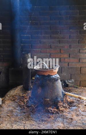 The distillation process of the fermented maguey in a artisanal Mezcal ...