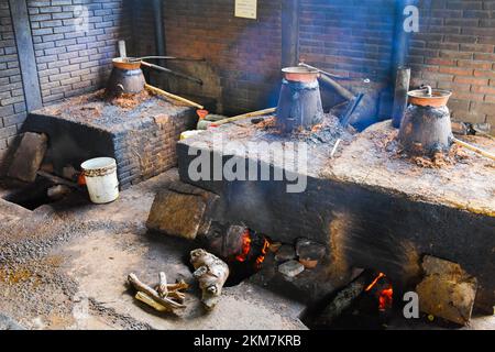 The distillation process of the fermented maguey in a artisanal Mezcal ...