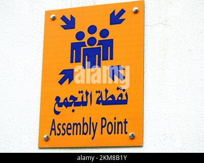 Assembly Point Sign in Arabic and English languages that uses safety ...
