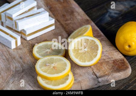 ripe yellow lemon cut into pieces on a chopping board, juicy yellow ...