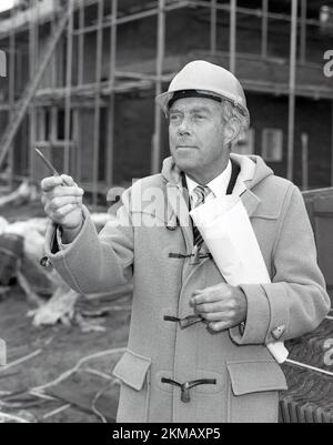 1980s, outside on a construction site, two workmen having a ...