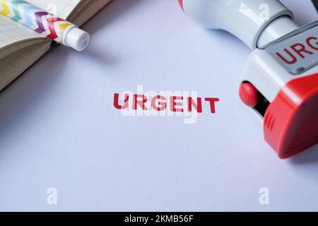Red URGENT word stamp on a white paper Stock Photo - Alamy