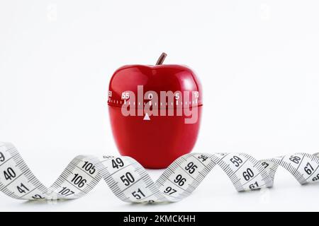 Time to lose weight concept. Red alarm clock with white plate and ...