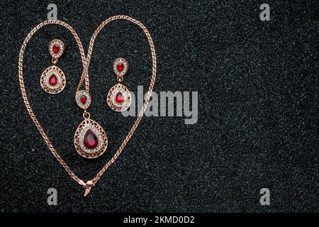 Photo of golden set with gems over dark background Stock Photo - Alamy