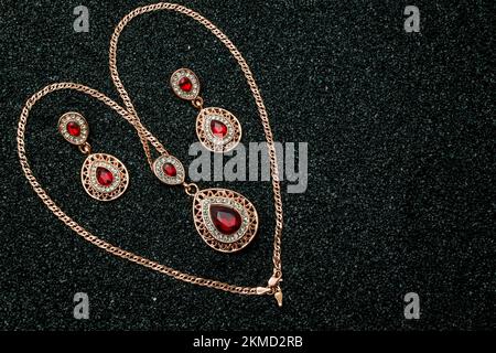 Photo of golden set with gems over dark background Stock Photo - Alamy