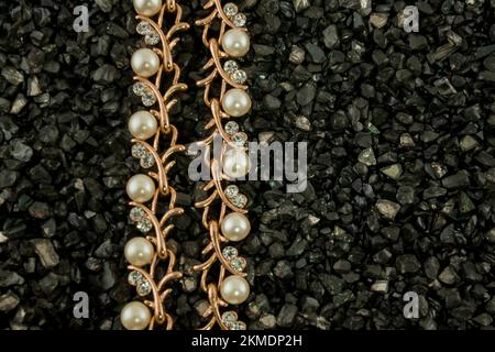 Photo of golden set with gems over dark background Stock Photo - Alamy