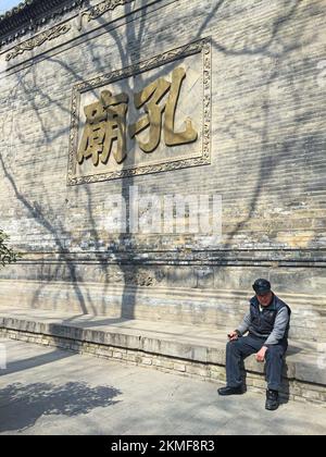 Lonely senior Chinese man sitting on sofa Stock Photo - Alamy