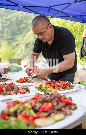 Happy Asian family with barbecue party at camping beach together Stock ...