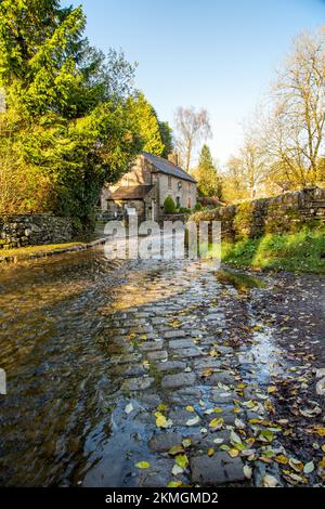 Hoo Brook flowing through the ford over the cobbled main street in the ...