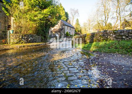 Hoo Brook flowing through the ford over the cobbled main street in the ...