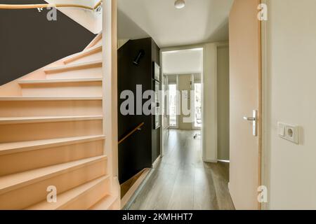 White spiral stairway connecting levels of contemporary house with ...