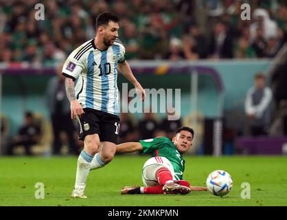 Argentina's Lionel Messi (left) and Mexico's Hirving Lozano battle for ...