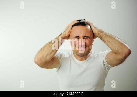 Adult man upset he put his hands on his face Prayer experience crying ...