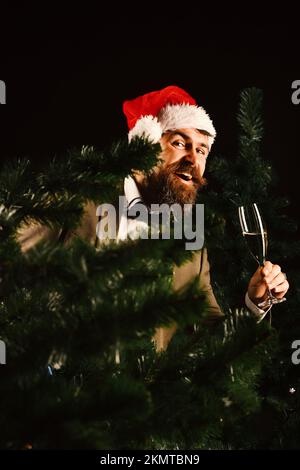 Manager with beard hides behind bald Christmas tree. Businessman with ...