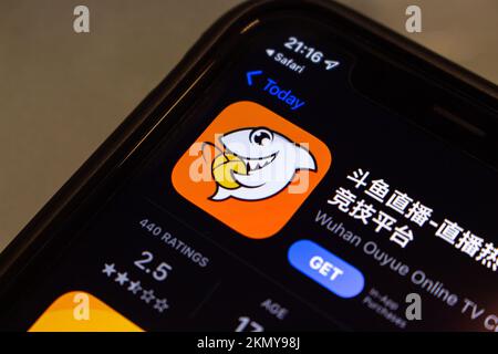 DouYu live streaming service logo on the smartphone screen behind the ...